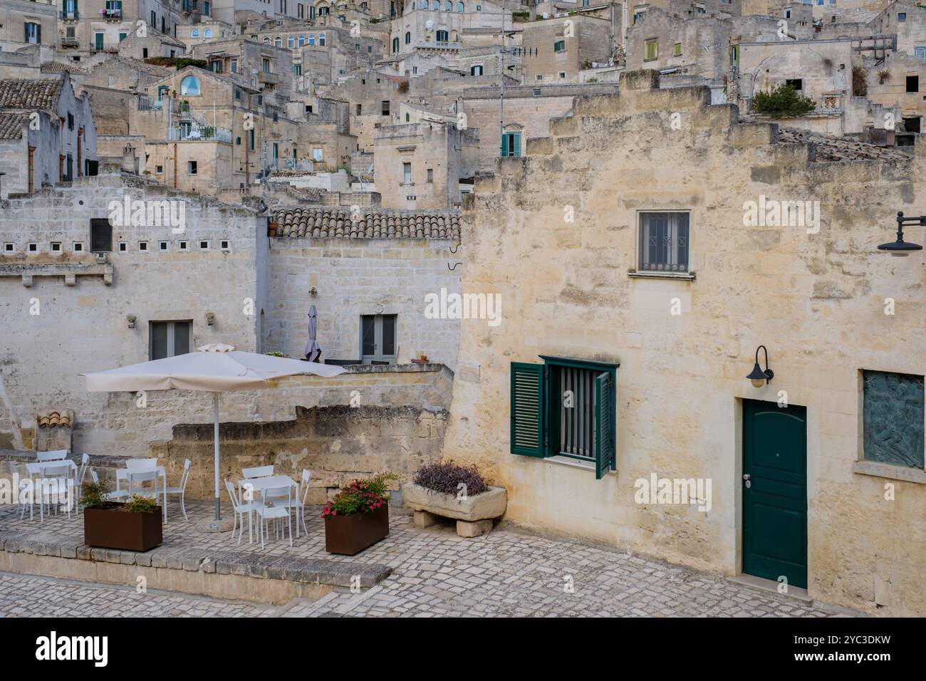 In the heart of Matera, Italy, beautiful stone buildings rise steeply ...