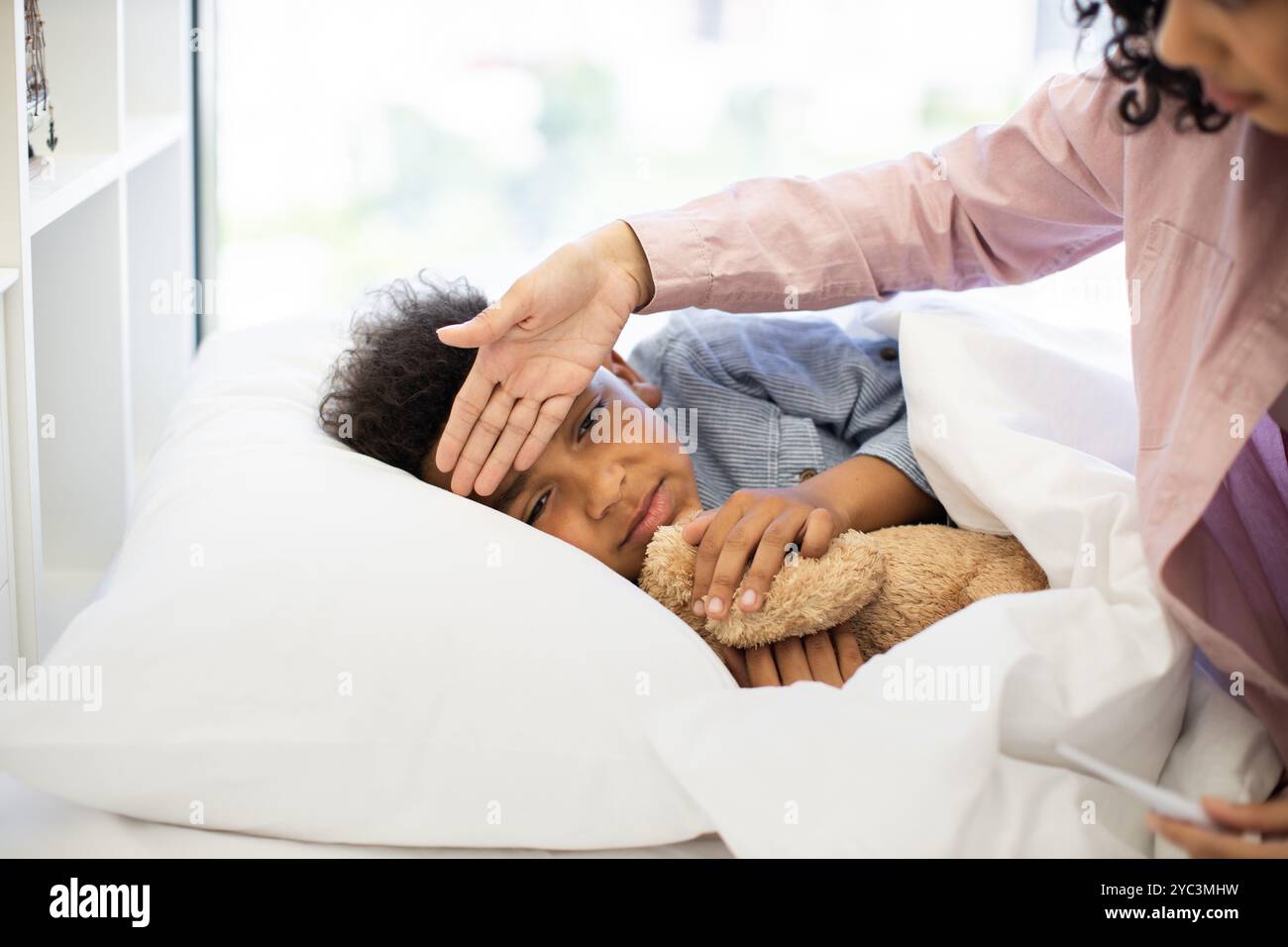 Caring for sick child with loving attention and comfort Stock Photo - Alamy