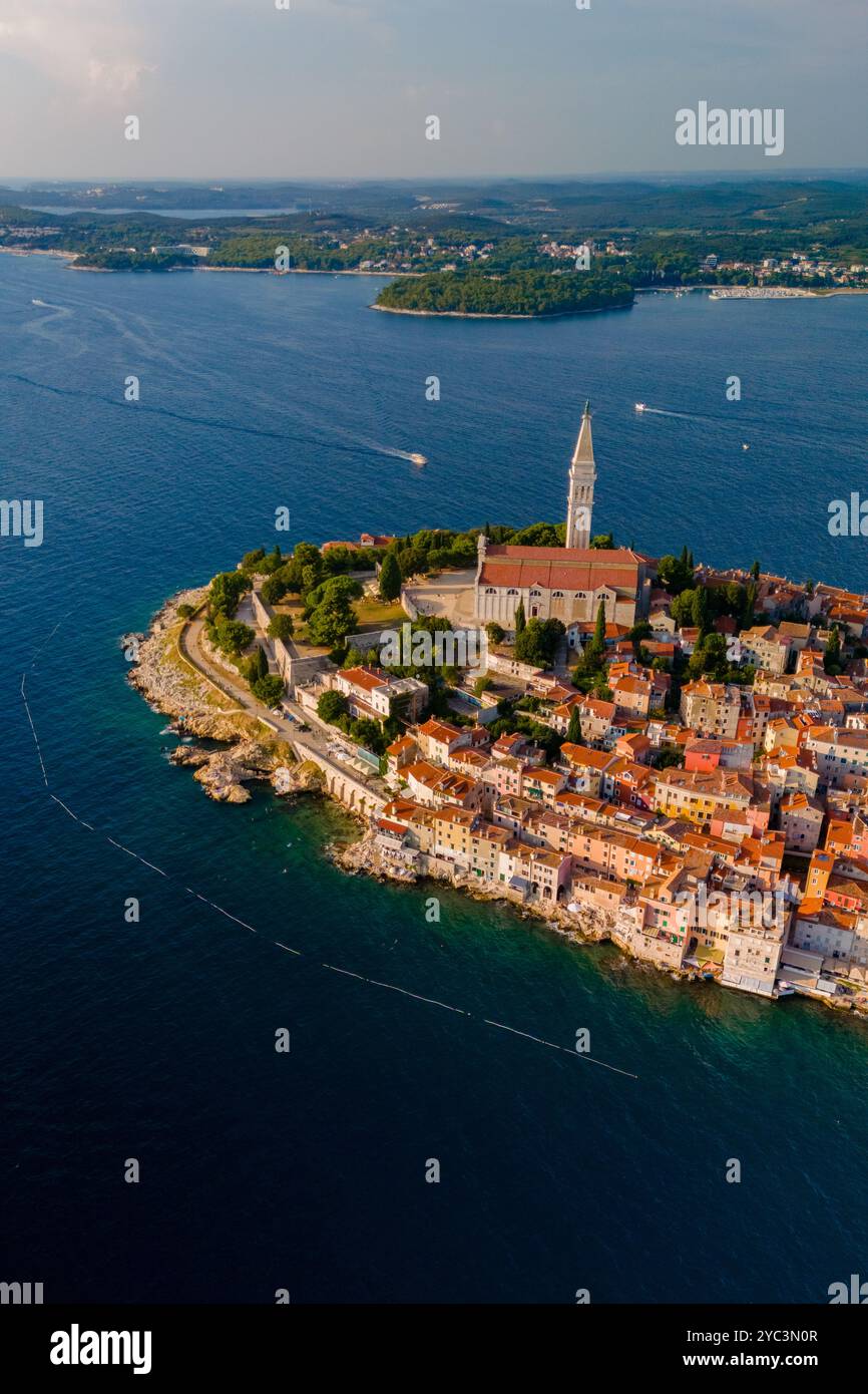 Rovinj's picturesque coastline unfolds under a clear sky, with vibrant ...