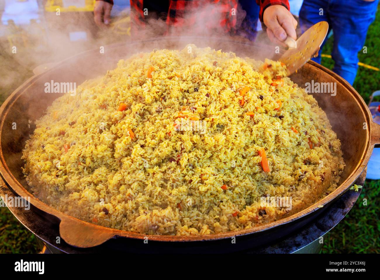 Turkish pilaf is cooked in large cast iron cauldron during cooking ...