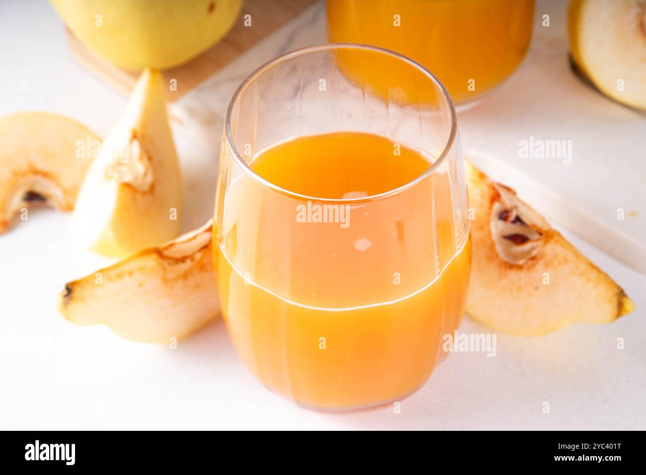 Fresh homemade apple quince juice in portioned glasses, with whole and ...