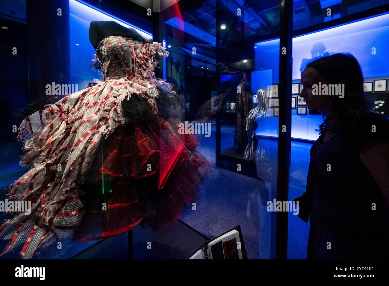 London, UK. 21 October 2024. A staff member views 'Alice's red dress ...