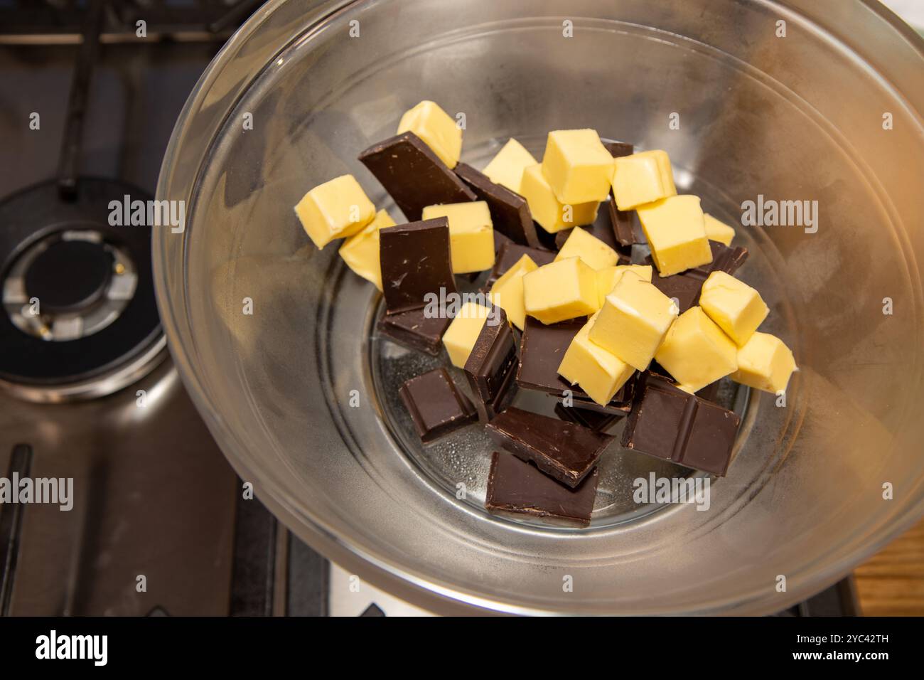 A selection of white and dark squares of chocolates being melted in a ...