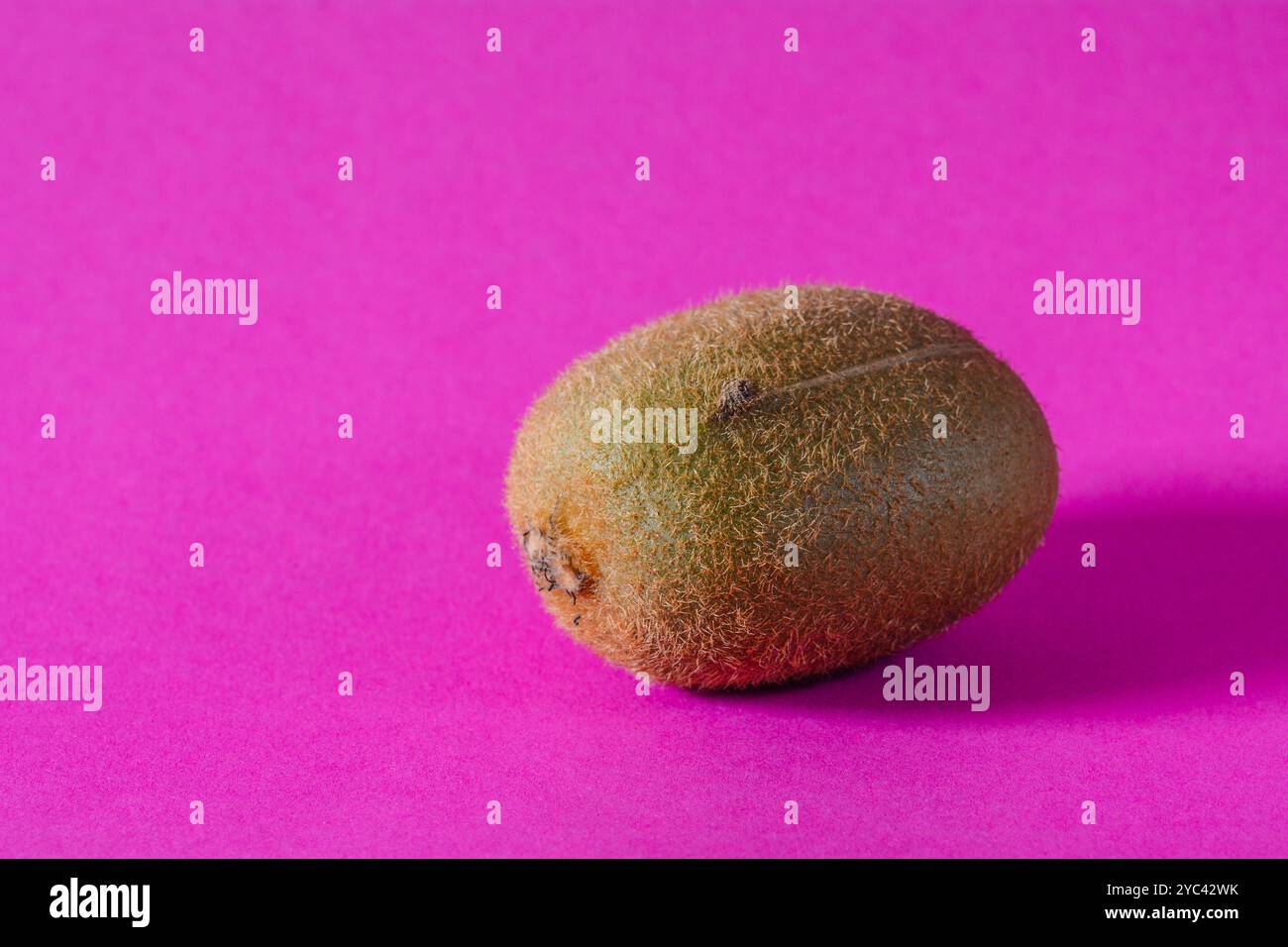Single kiwi fruit isolated on pink background with text space Stock ...