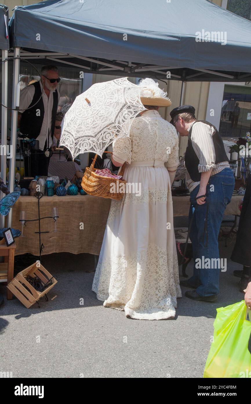 Woman in early 1900s clothing and with an umbrella at an Old Fashioned ...