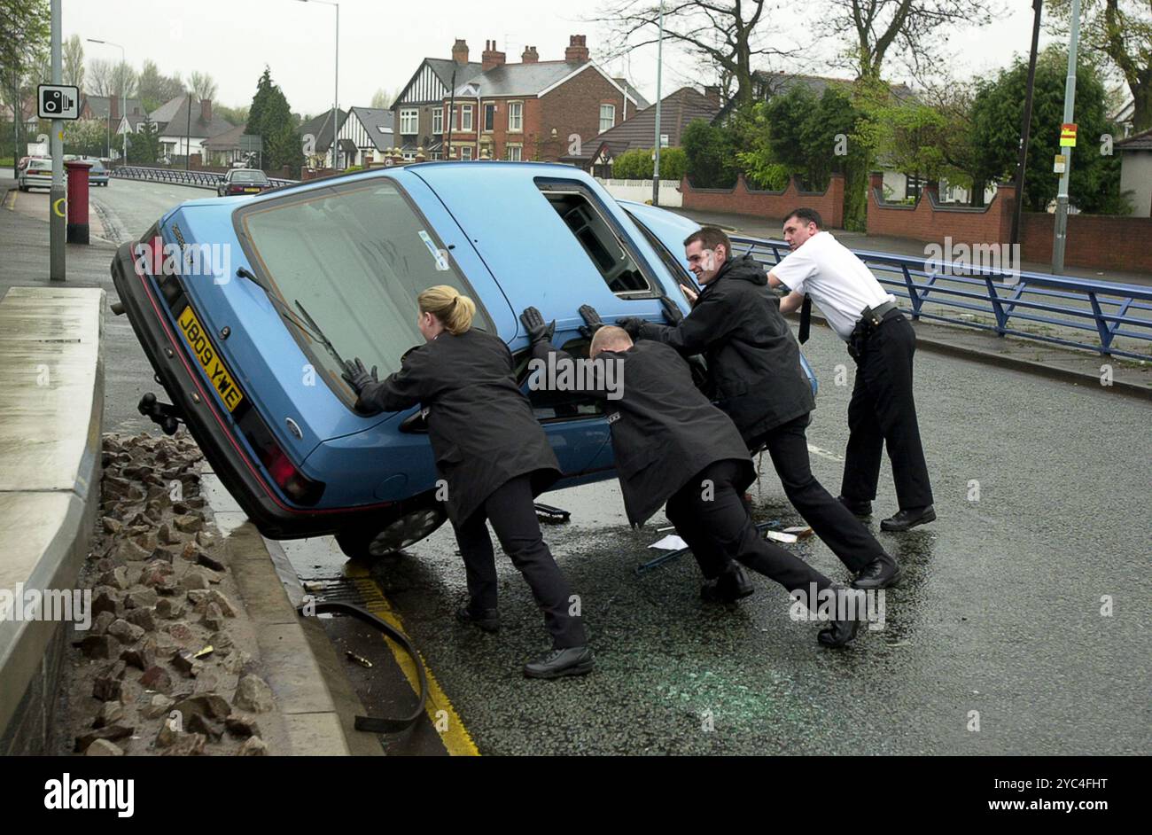 West Midlands police officers pushing an overturned Ford Sierra back on ...