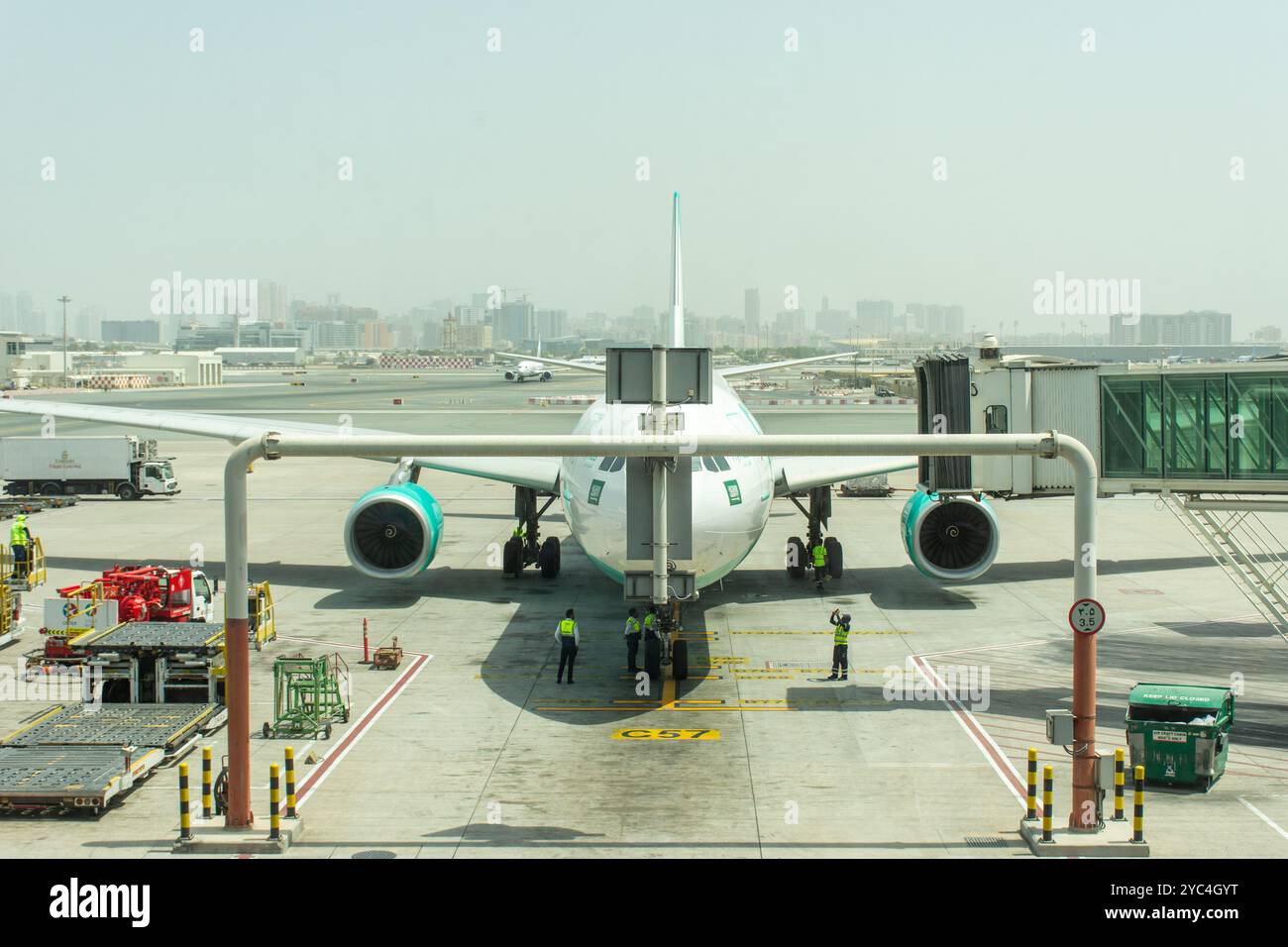 A Flynas aircraft parked at the gate with a jet bridge connected at ...