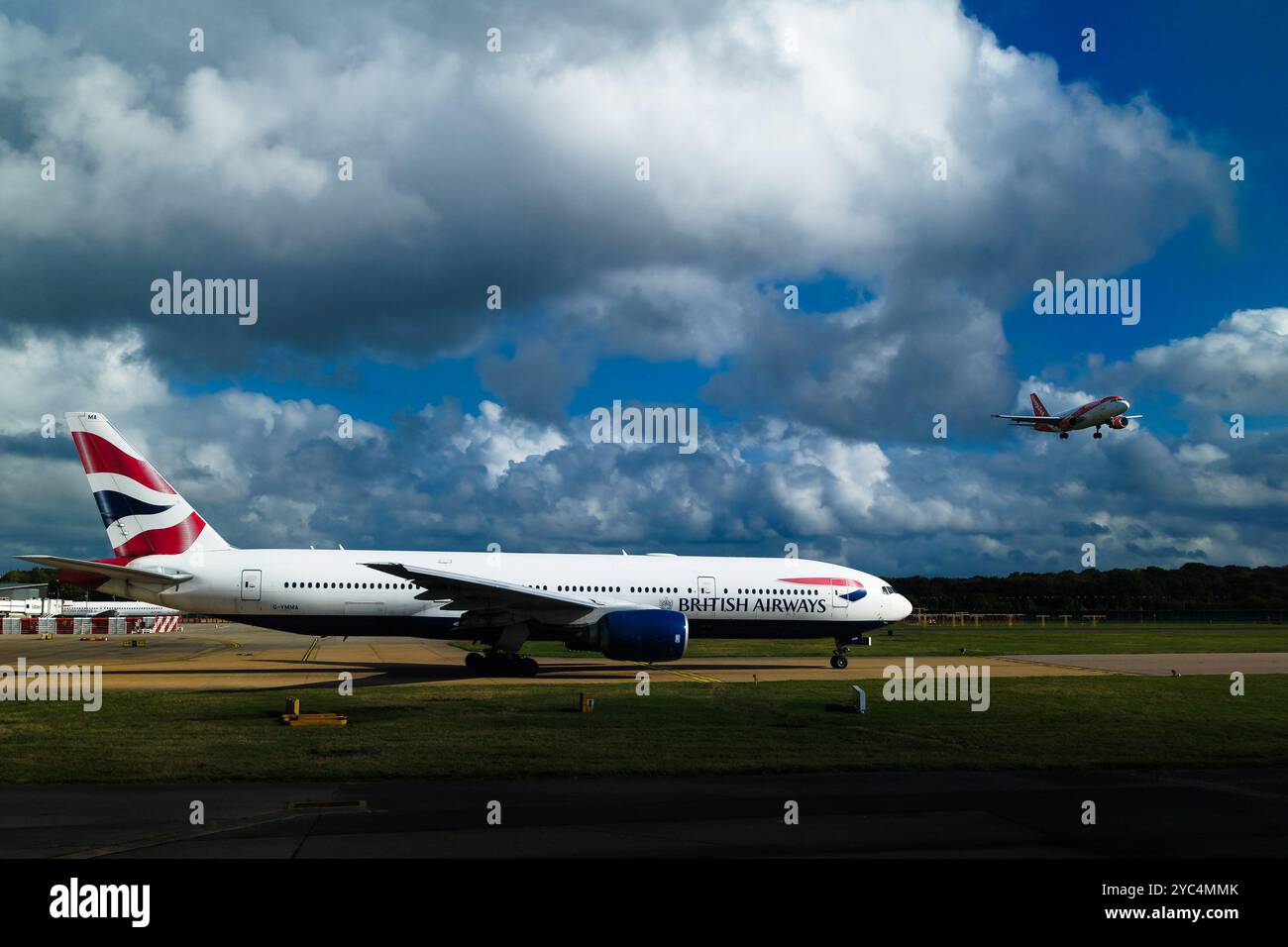 A British Airways Boeing 777-236 waits to take off as another aircraft ...