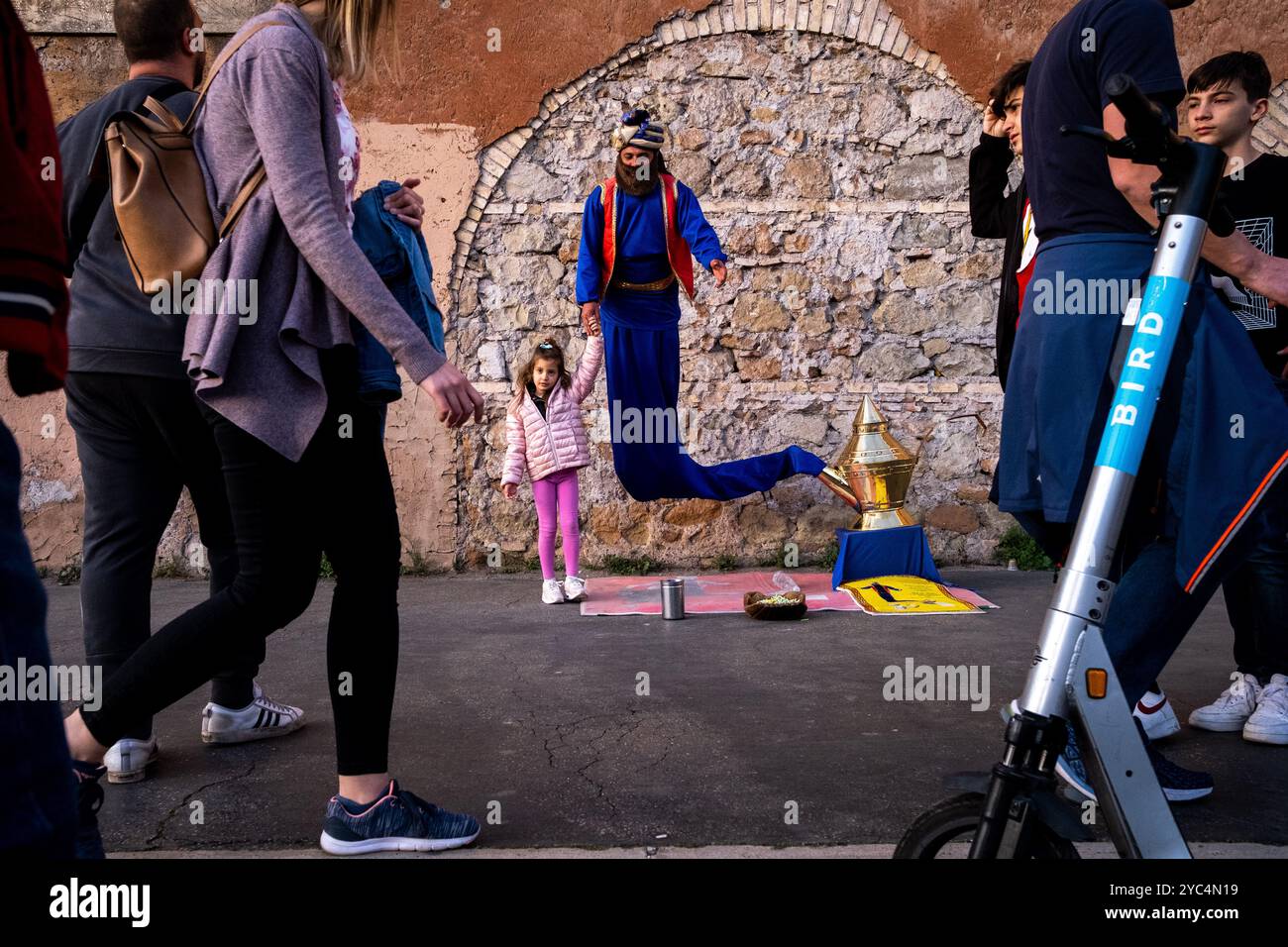 Child at an attraction for tourists of a genius that comes out of a ...