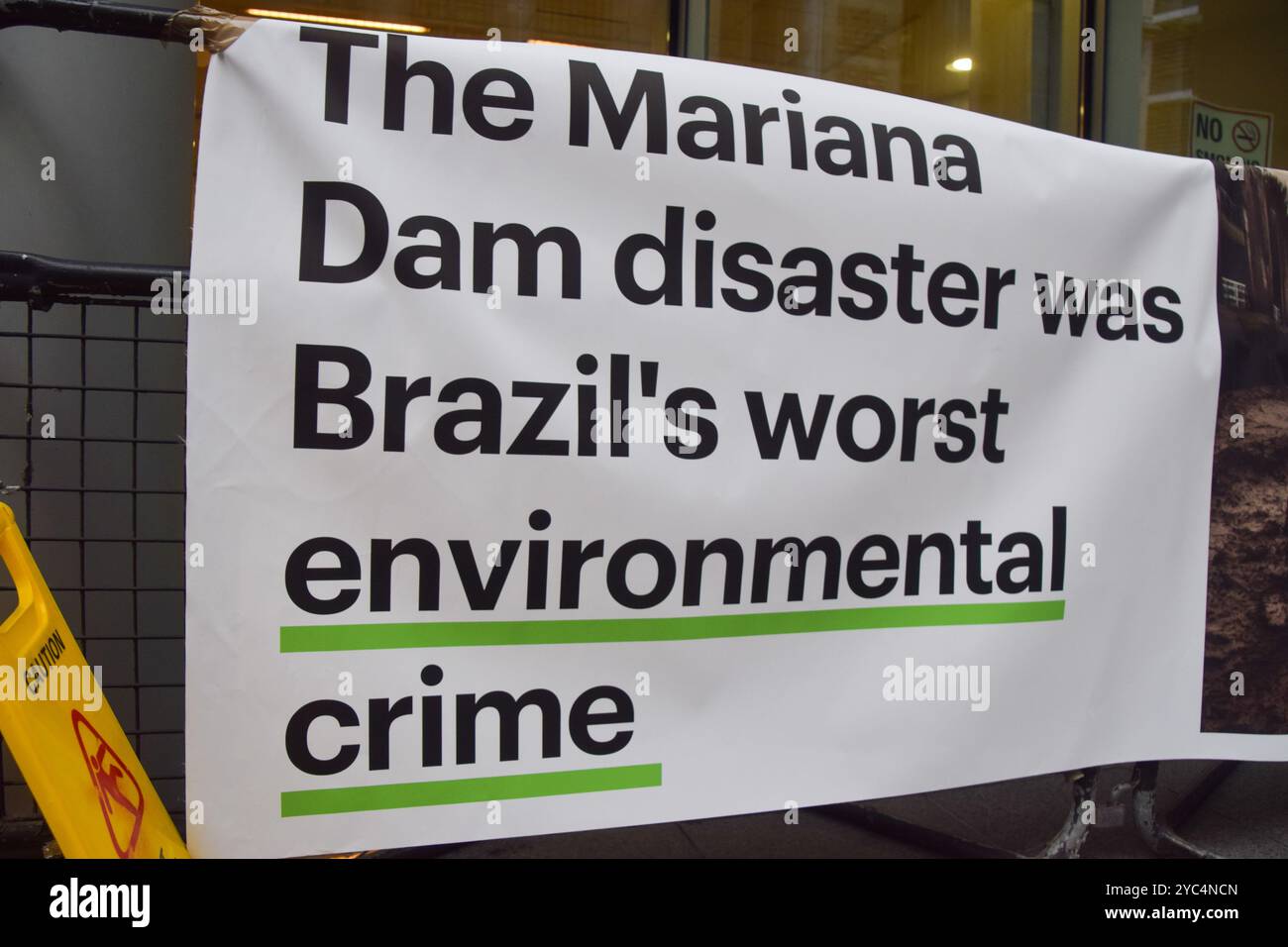 London, UK. 21st Oct, 2024. A banner about the Mariana Dam disaster ...