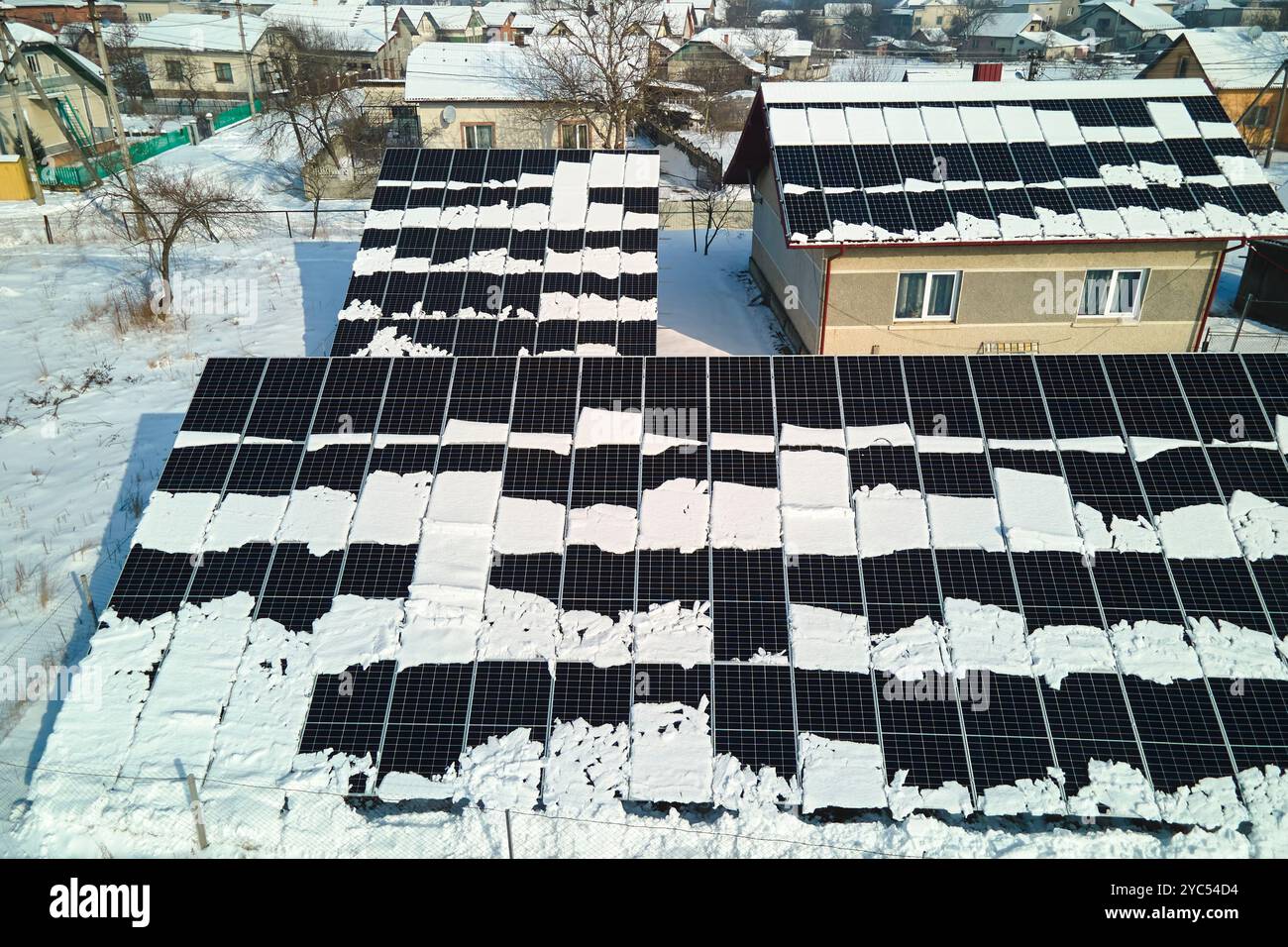Aerial view of snow melting from covered solar photovoltaic panels ...