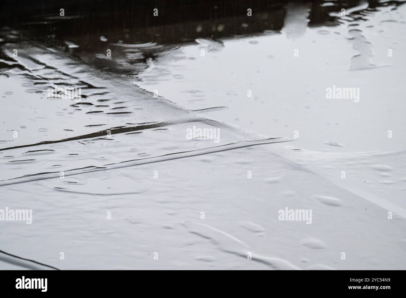 Wet surface of a black rooftop during heavy rain in Brussels, Belgium ...