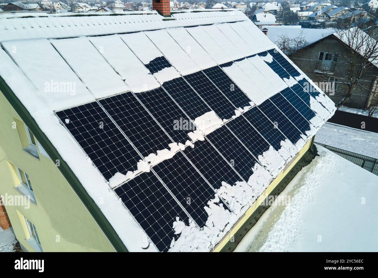 Aerial view of snow melting from covered solar photovoltaic panels ...