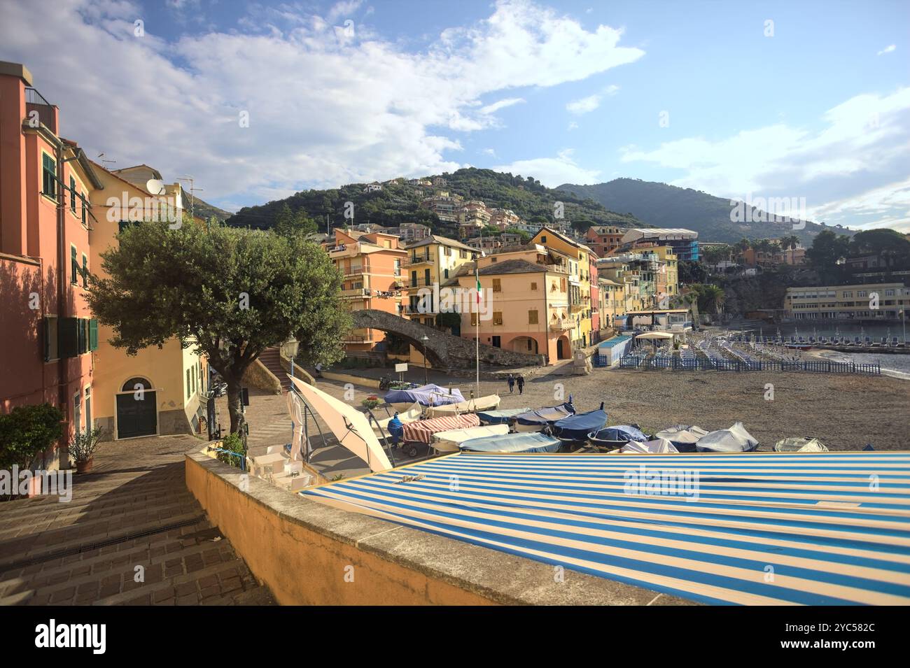 Bogliasco, Italy - September 2024 - Pebble beach and a stone bridge at ...