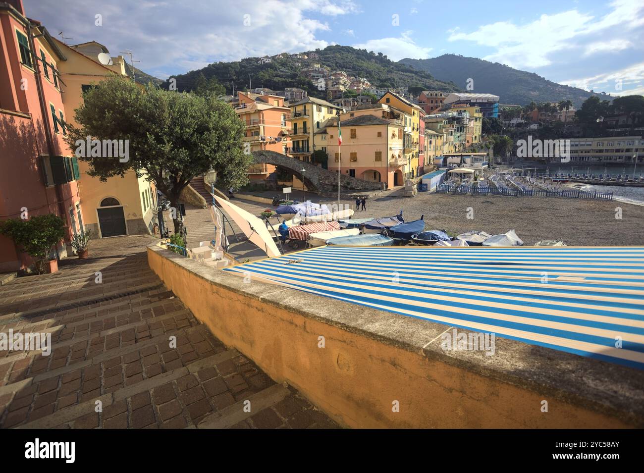 Bogliasco, Italy - September 2024 - Pebble beach and a stone bridge at ...