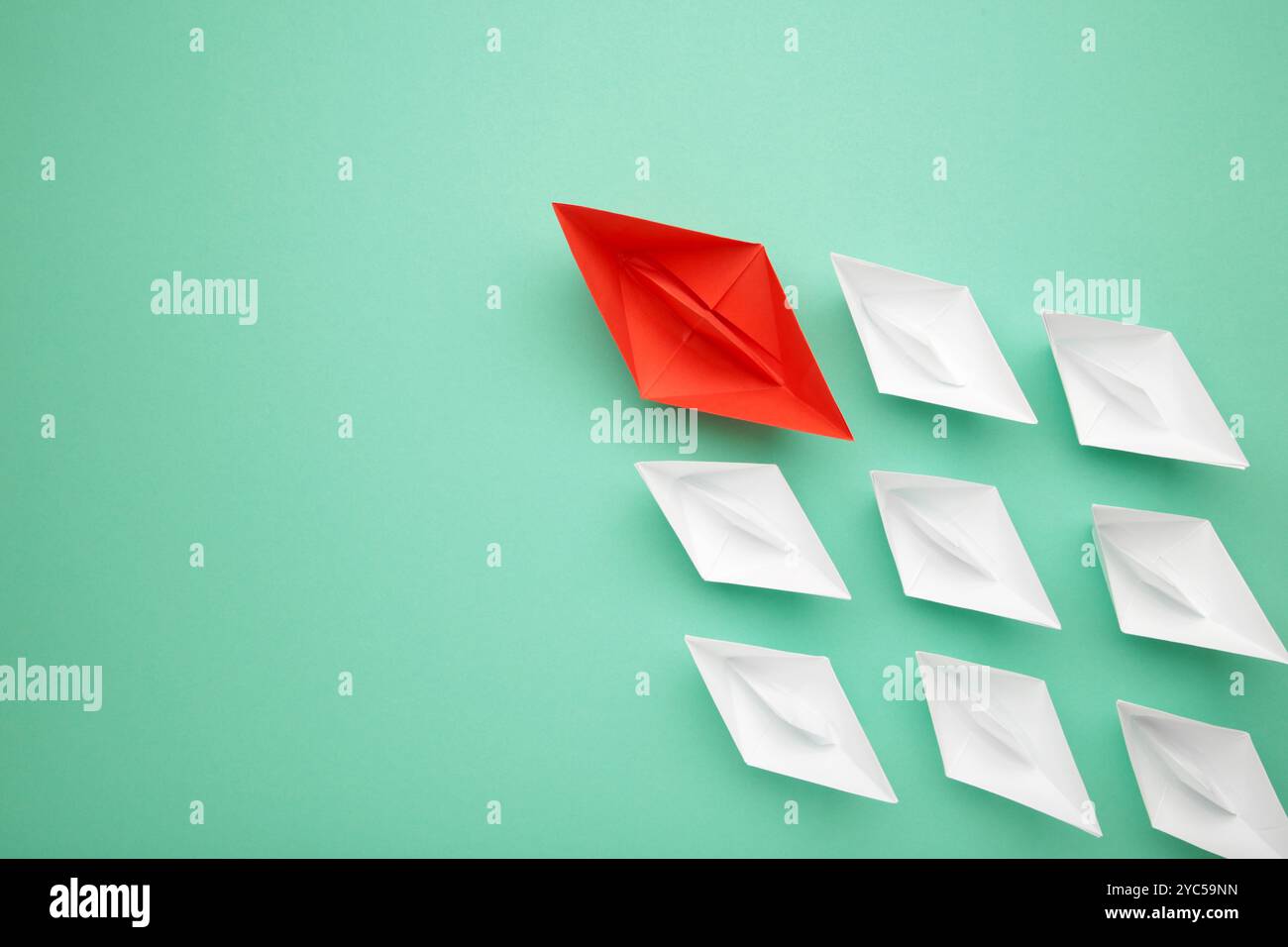 Leadership concept. Red leader paper ship leading among white on mint ...