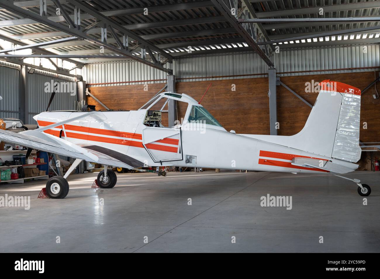 Small private lightweight propeller airplane in hangar, closeup photo ...