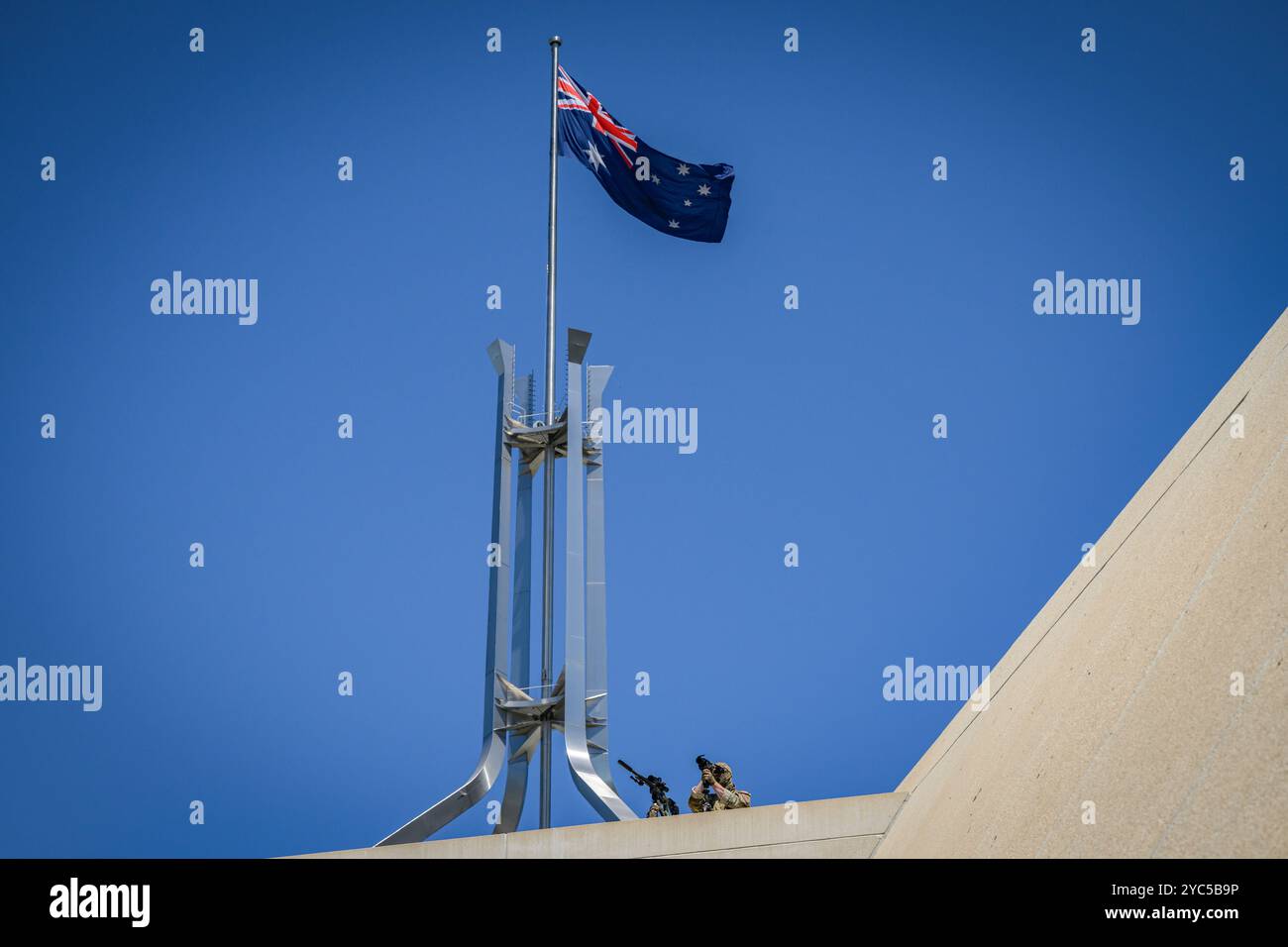 Canberra, Australia. 21st Oct, 2024. A spinier is seen guarding at the rooftop of the Parliament ...