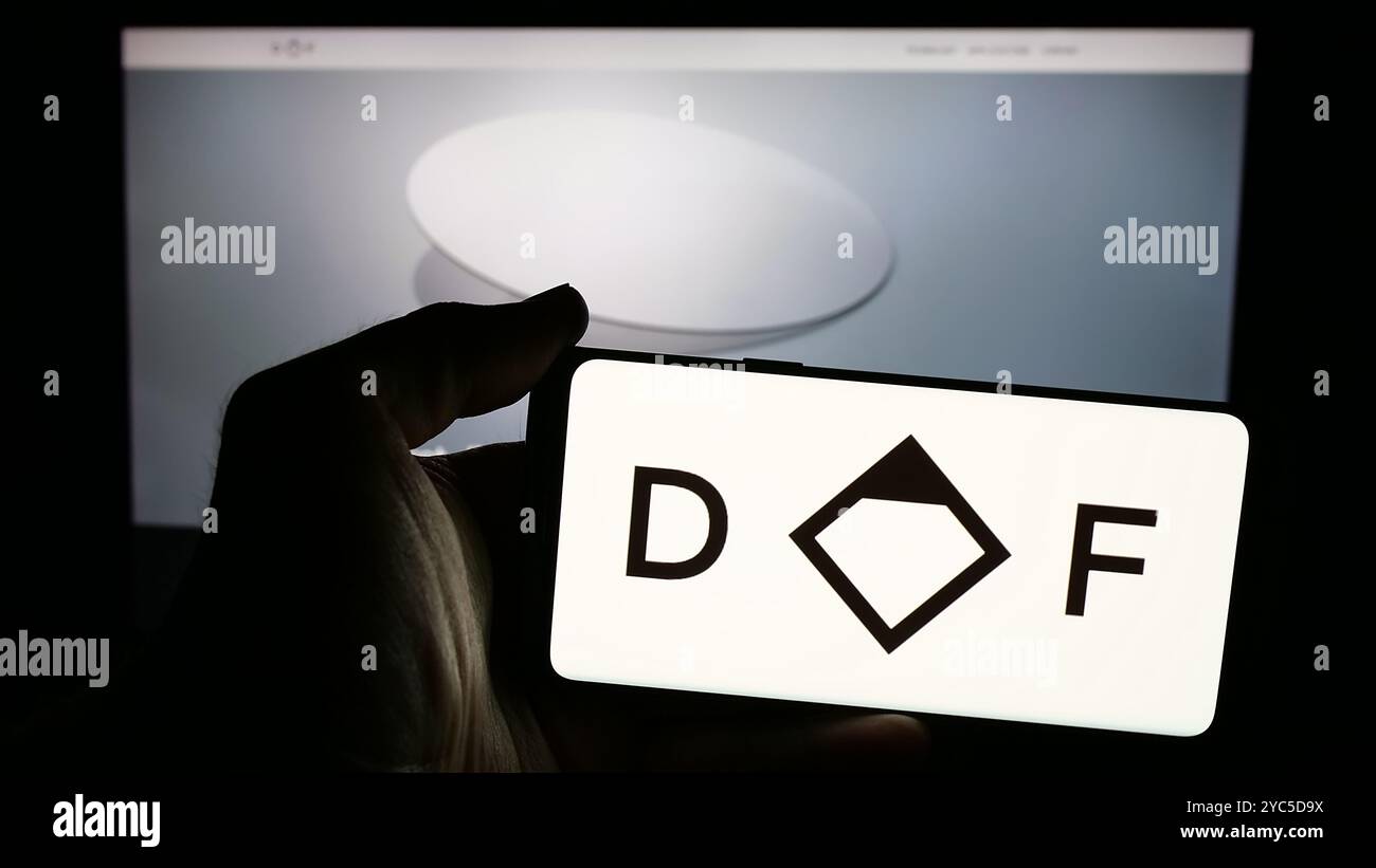 Person holding smartphone with logo of US diamonds company Diamond ...