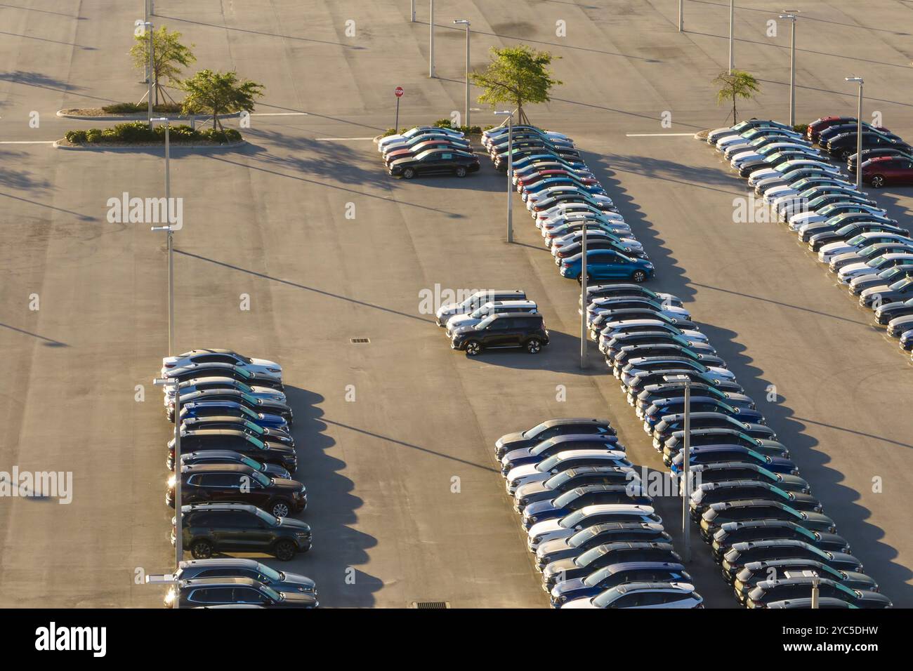 Aerial view of dealership parking lot with many brand new cars for sale ...