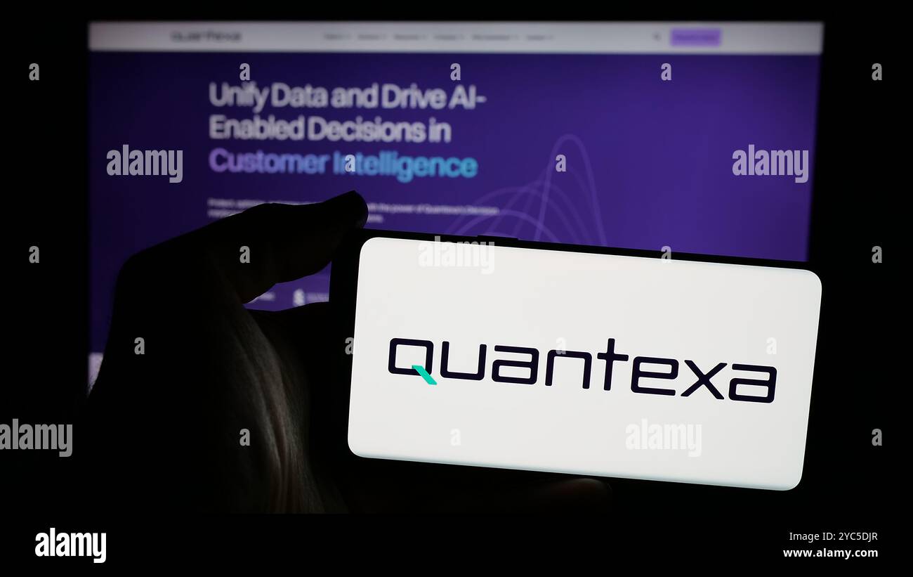 Person holding smartphone with logo of British data analytics company ...