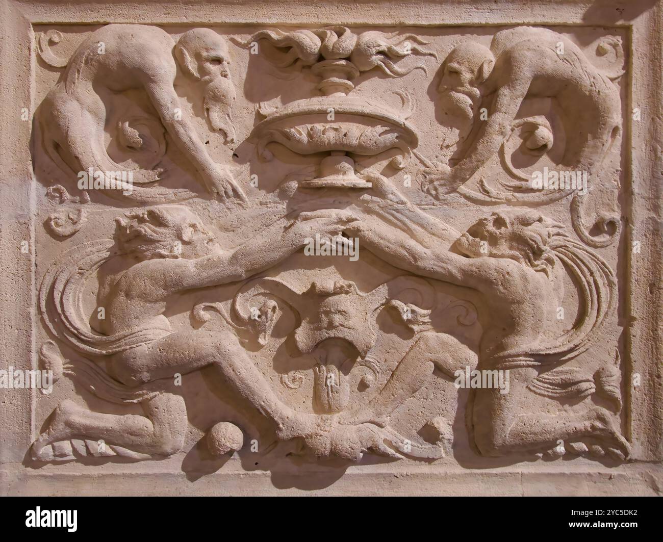 Stone carved wall relief with grotesque half human creatures in the ...