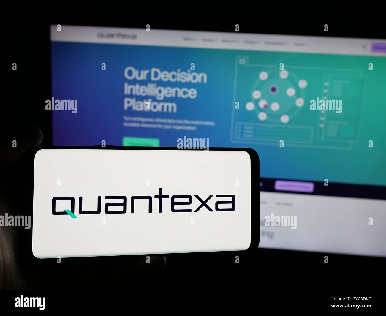 Person holding mobile phone with logo of British data analytics company ...