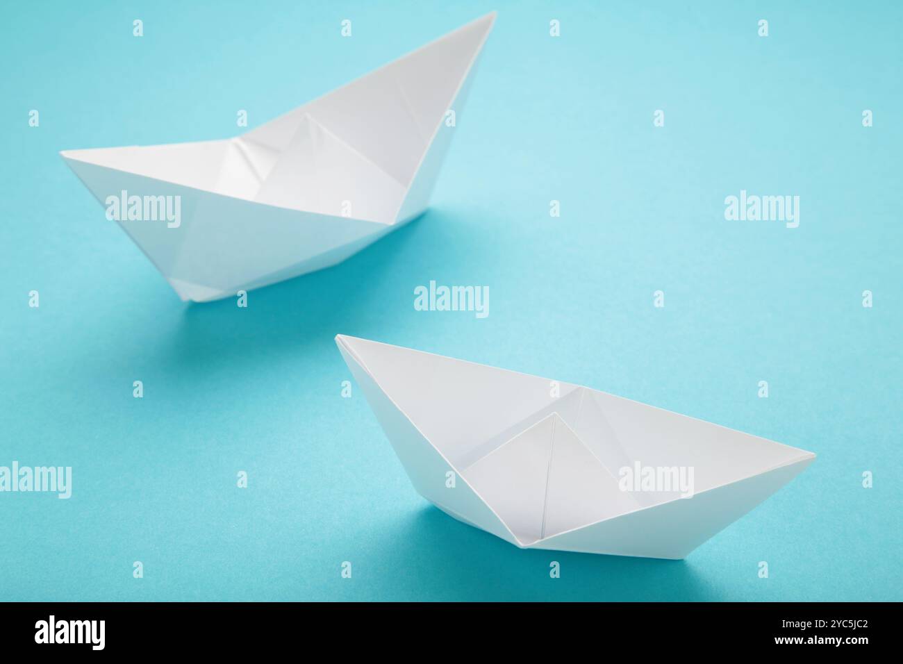 White paper ships on blue background indicate direction, unity ...
