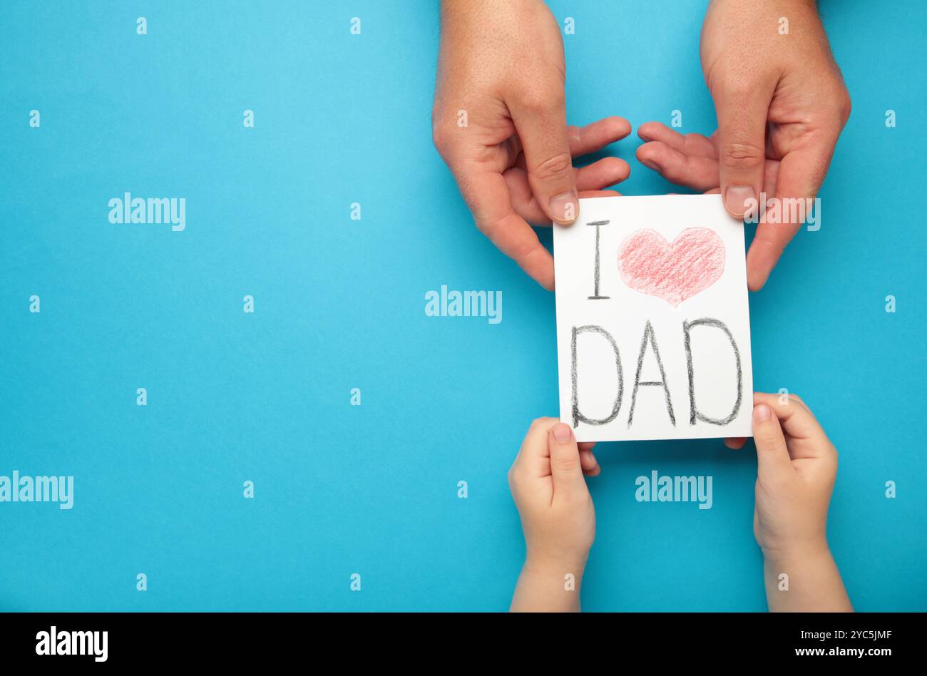 Father's Day. Child hands gives father's day greeting card to her ...