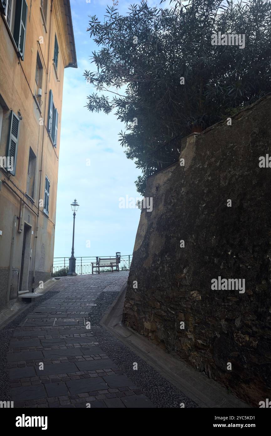 Bend in a cobbled alley between tall buildings in an italian town Stock ...