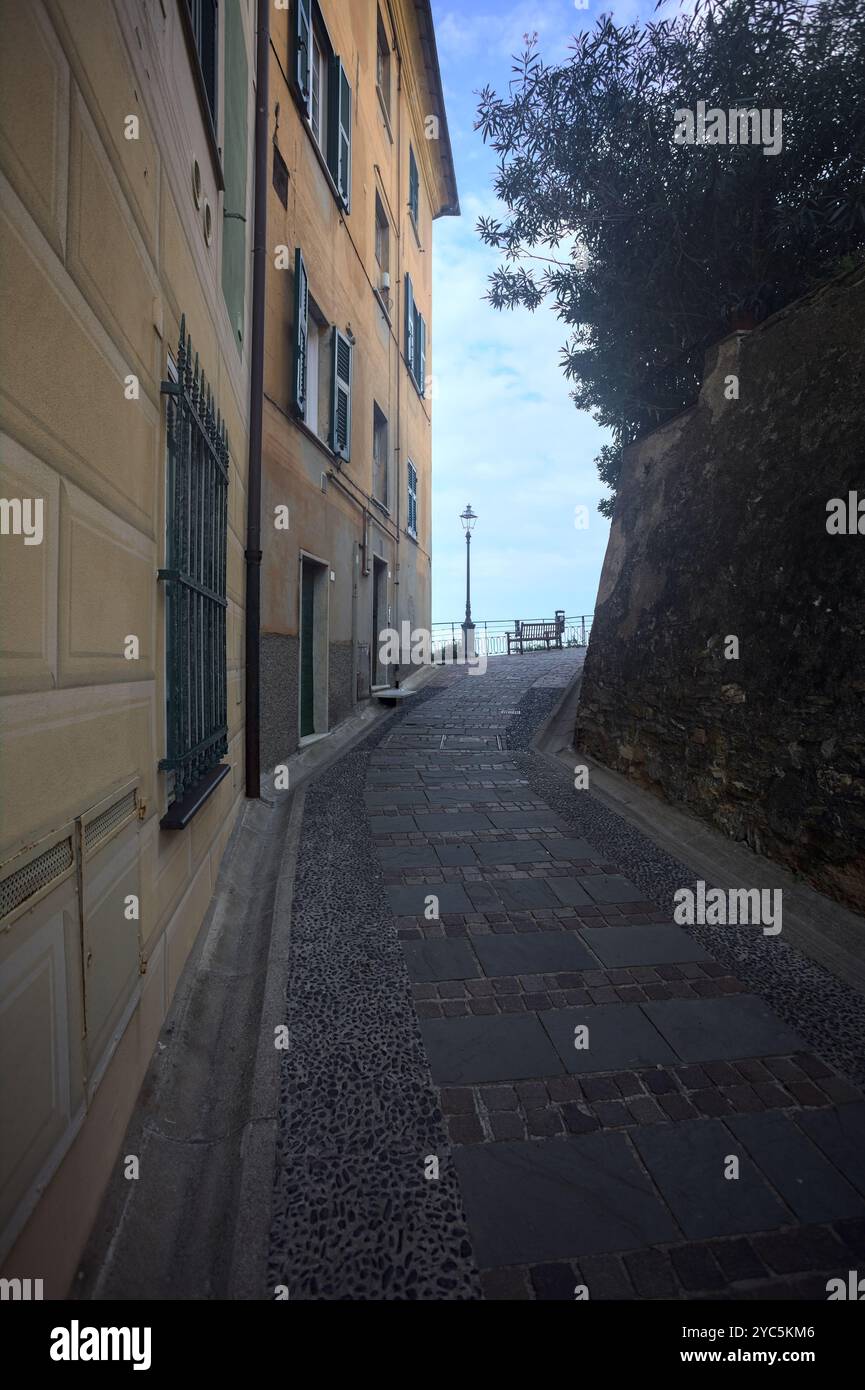 Bend in a cobbled alley between tall buildings in an italian town Stock ...