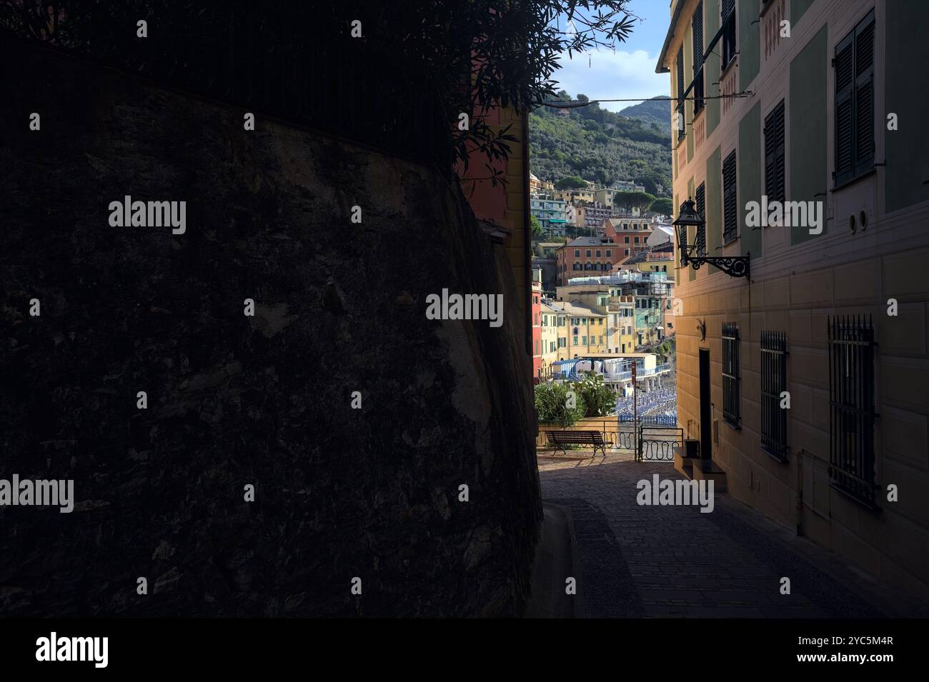 Bend in a cobbled alley between tall buildings in an italian town Stock ...