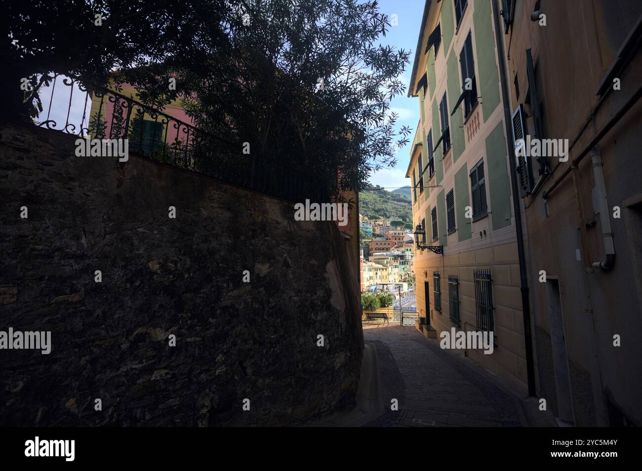 Bend in a cobbled alley between tall buildings in an italian town Stock ...