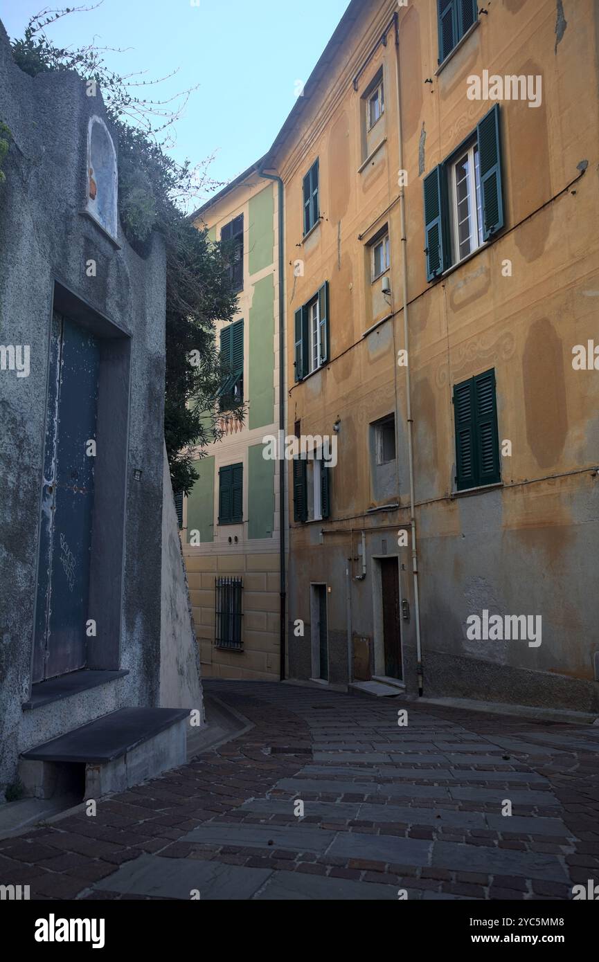 Bend in a cobbled alley between tall buildings in an italian town Stock ...