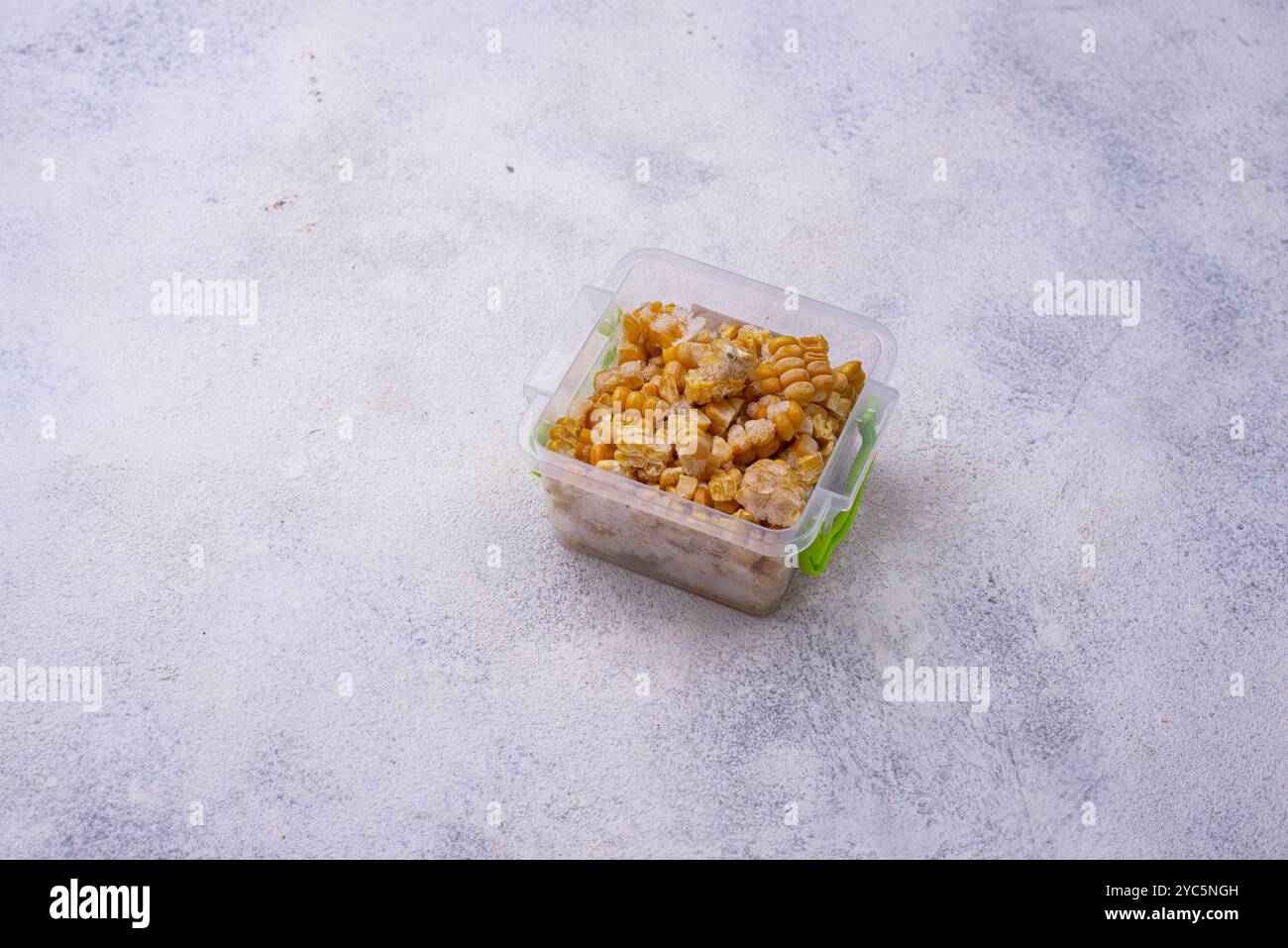 Frozen corn in plastic container Stock Photo - Alamy