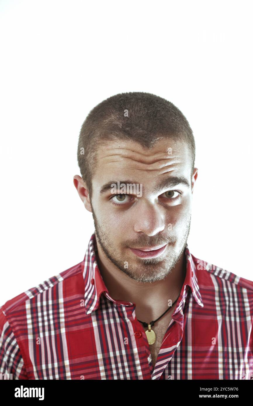 Confident young man with a stylish goatee poses happily in a red ...