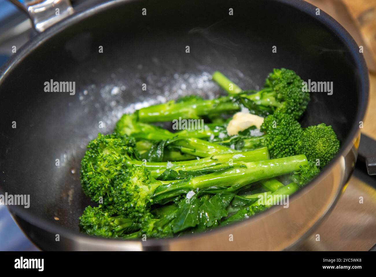 A pan or delicious broccoli cooking in a pan with a pinch of salt Stock ...