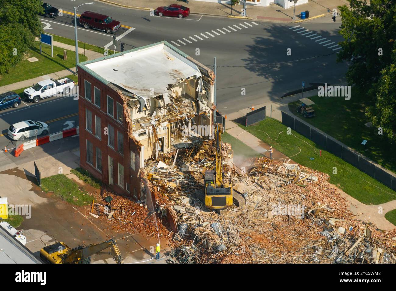 Old building demolition site. Construction excavator tearing down ...