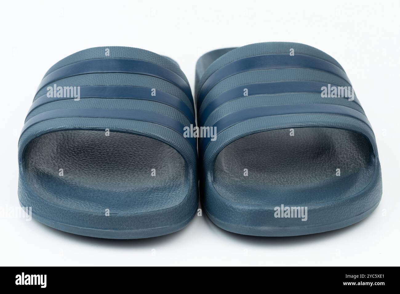 Blue slide sandals feature simple design ideal for lounging at home or ...