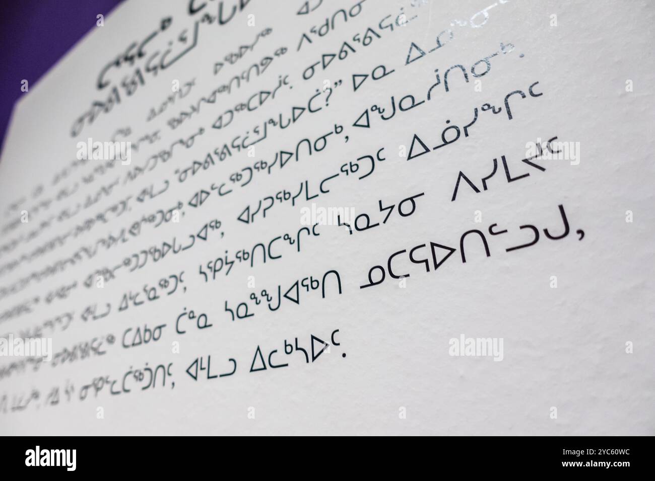 Text in the Inuktitut language displayed on a wall Stock Photo - Alamy