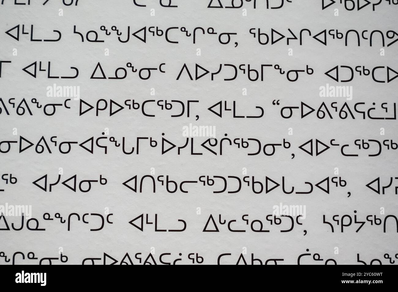 Text in the Inuktitut language displayed on a wall Stock Photo - Alamy