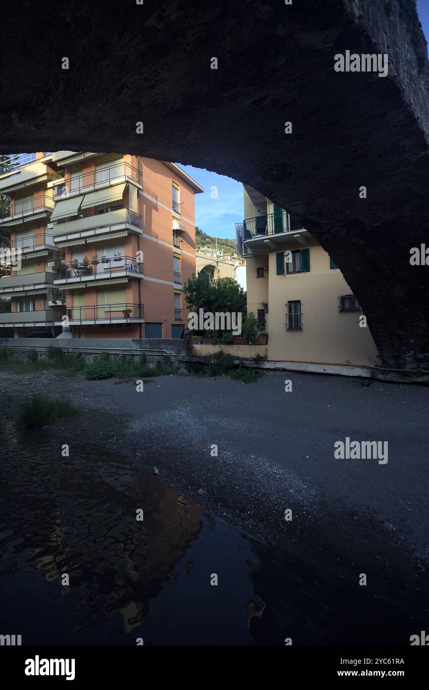 Pebble beach and a stone bridge at a creek outlet at sunset Stock Photo ...