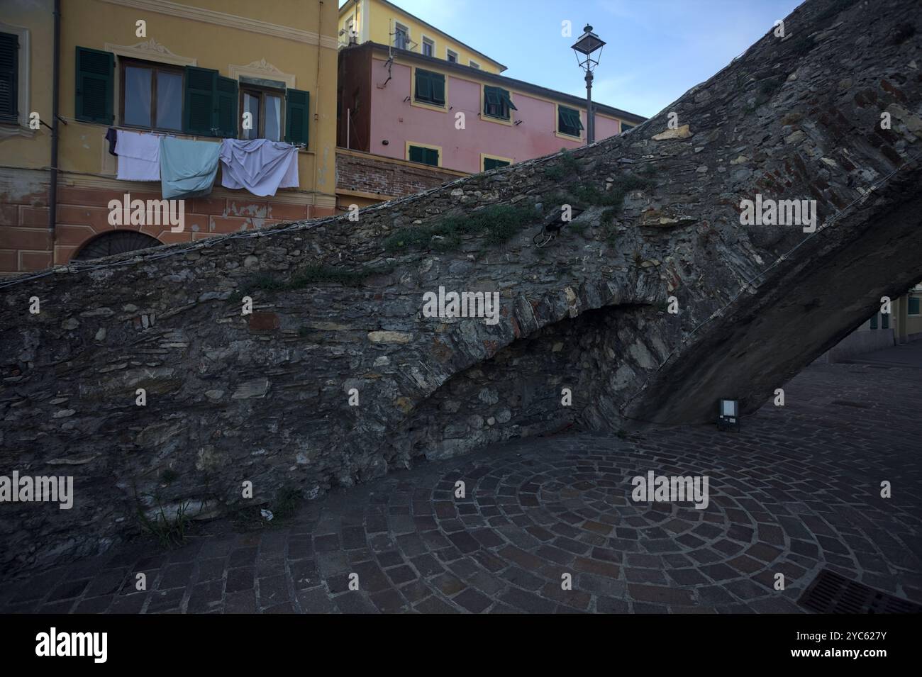 Pebble beach and a stone bridge at a creek outlet at sunset Stock Photo ...