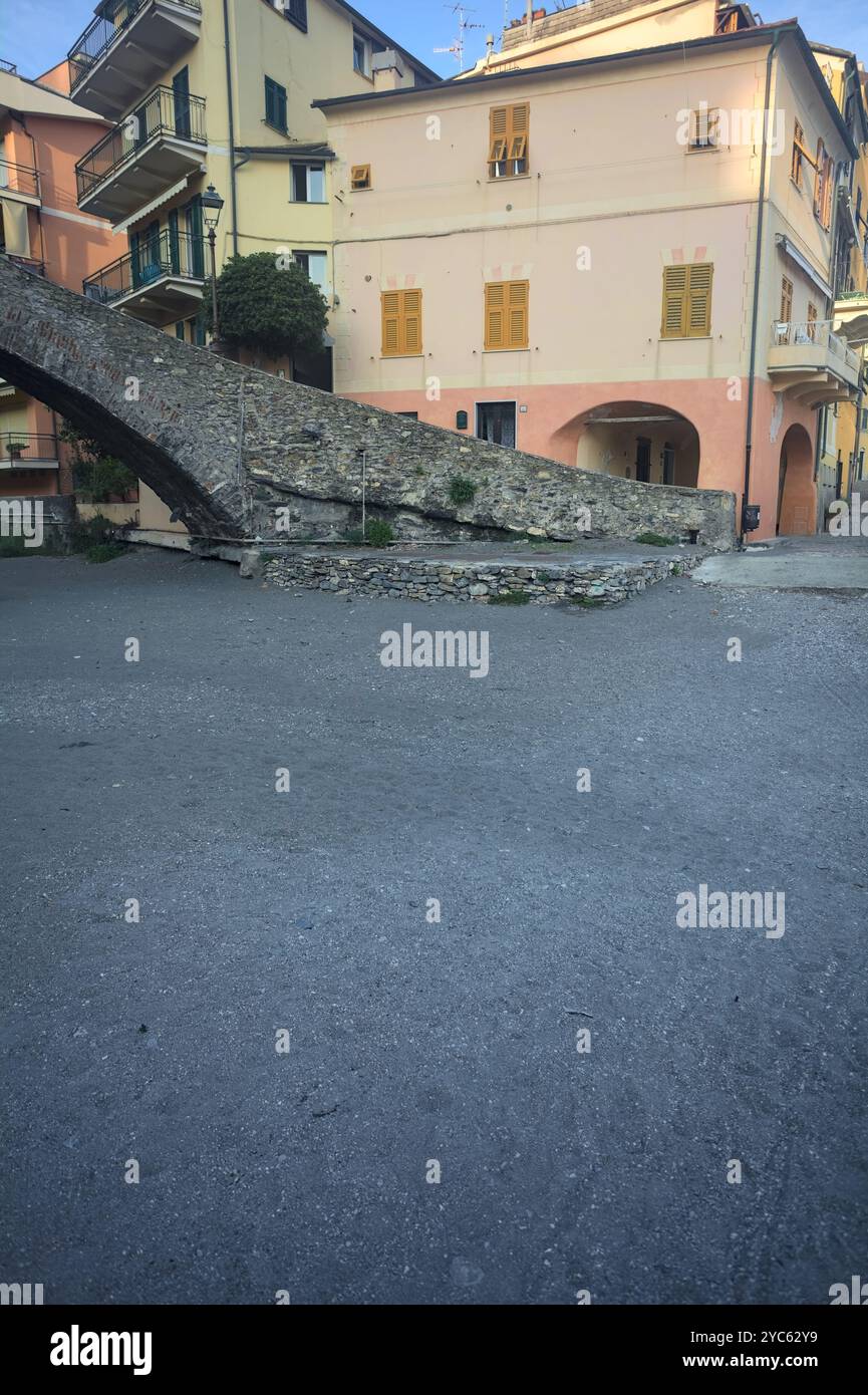 Pebble beach and a stone bridge at a creek outlet at sunset Stock Photo ...