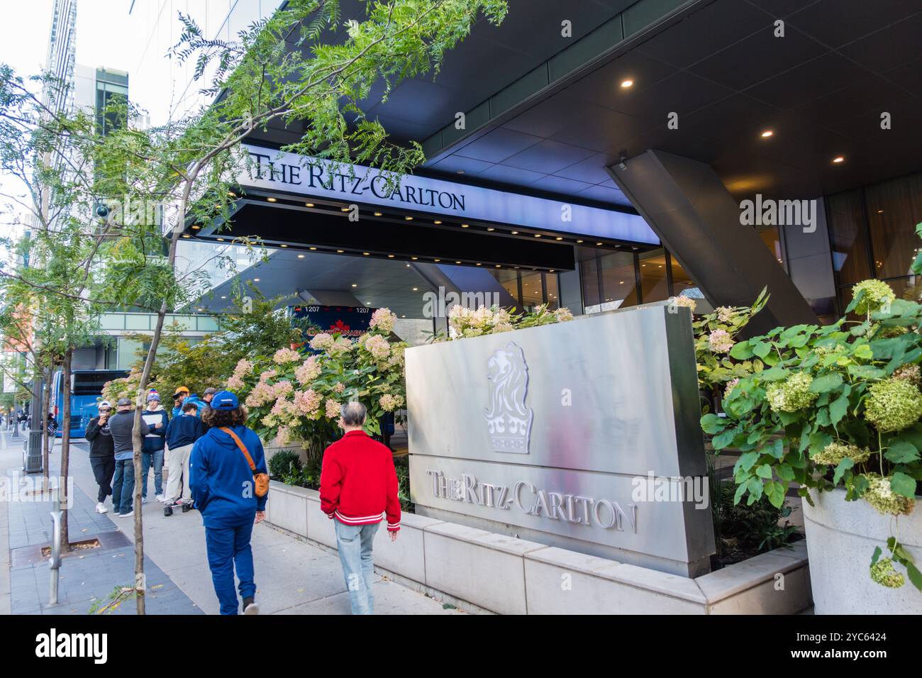 A group of fans waiting outside The Ritz-Carlton Hotel in Toronto ...
