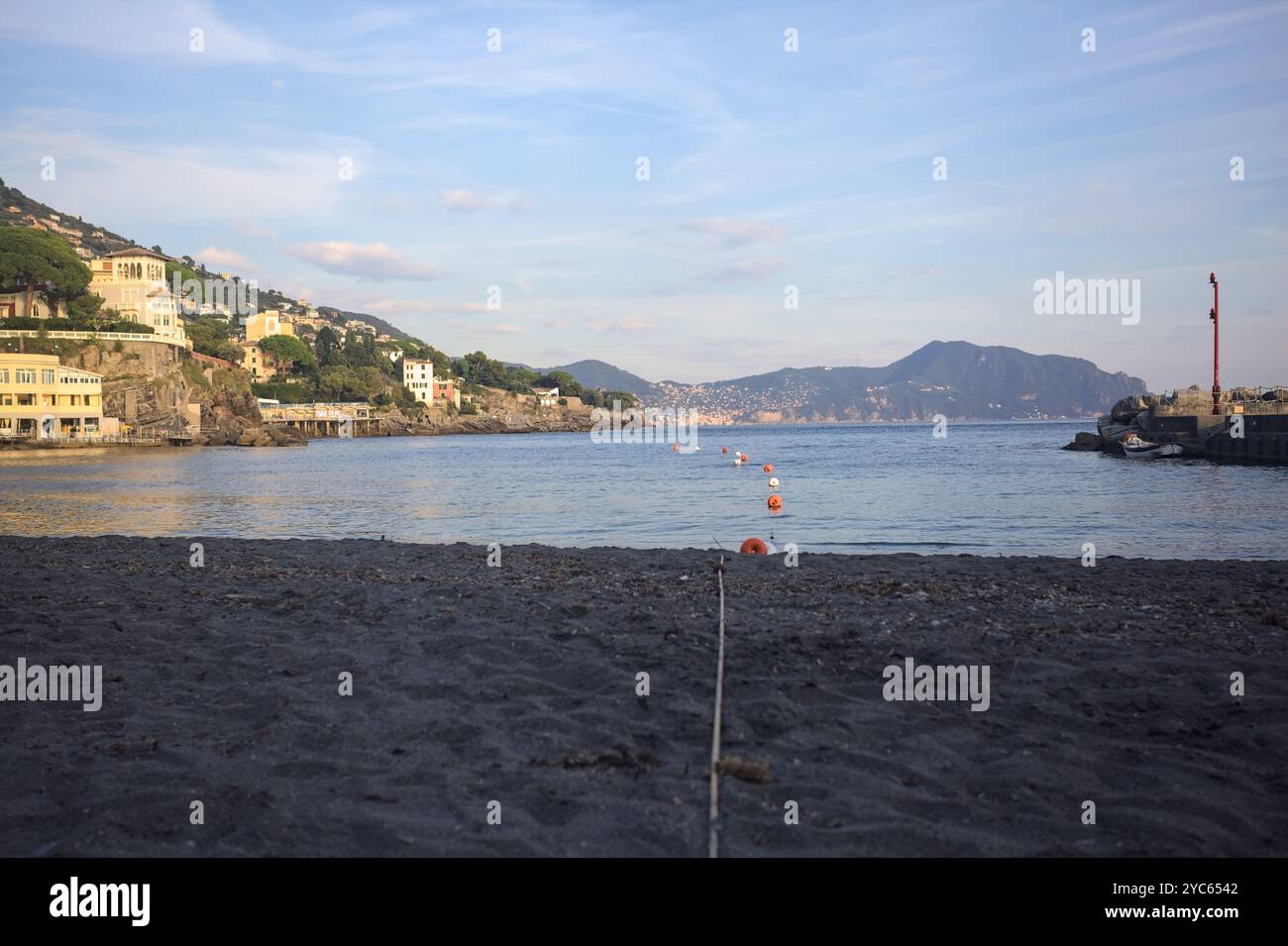 Beach in a cove of an italian town at twilight Stock Photo - Alamy