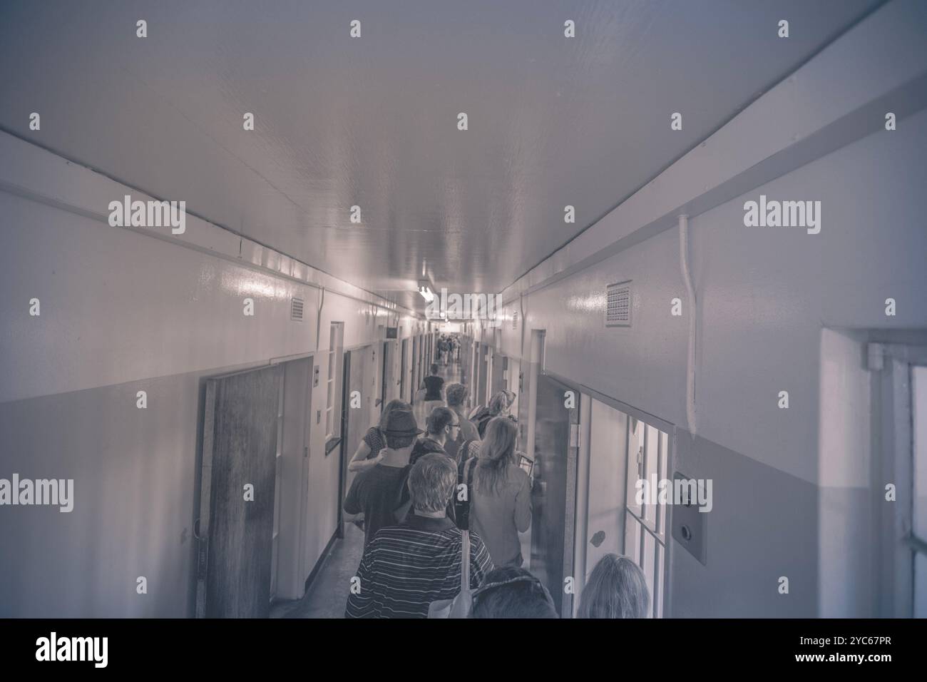 Tourists walk through Robben Island prison corridor Stock Photo - Alamy
