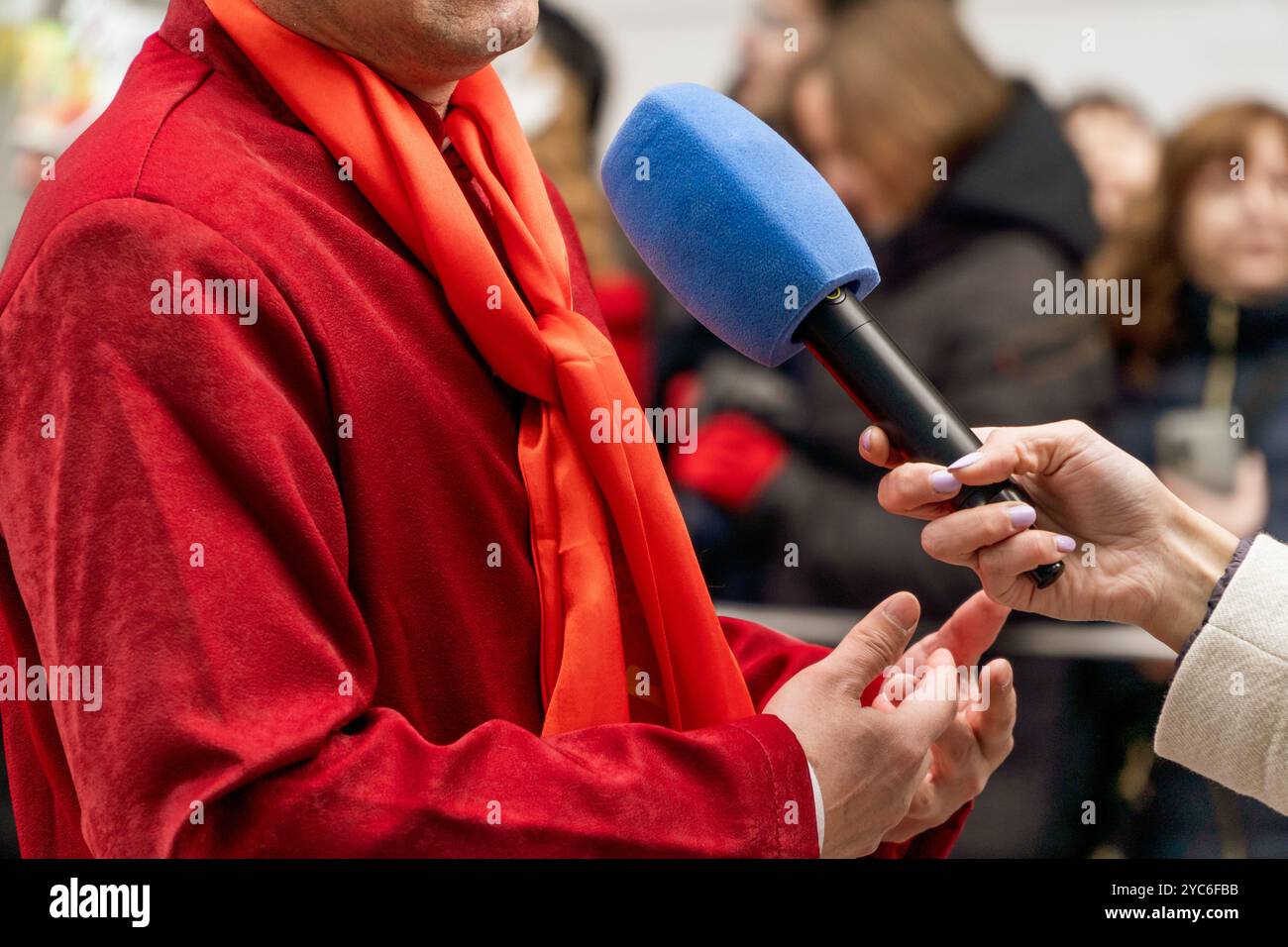 Television reporter with microphone in an interview for the news on an ...