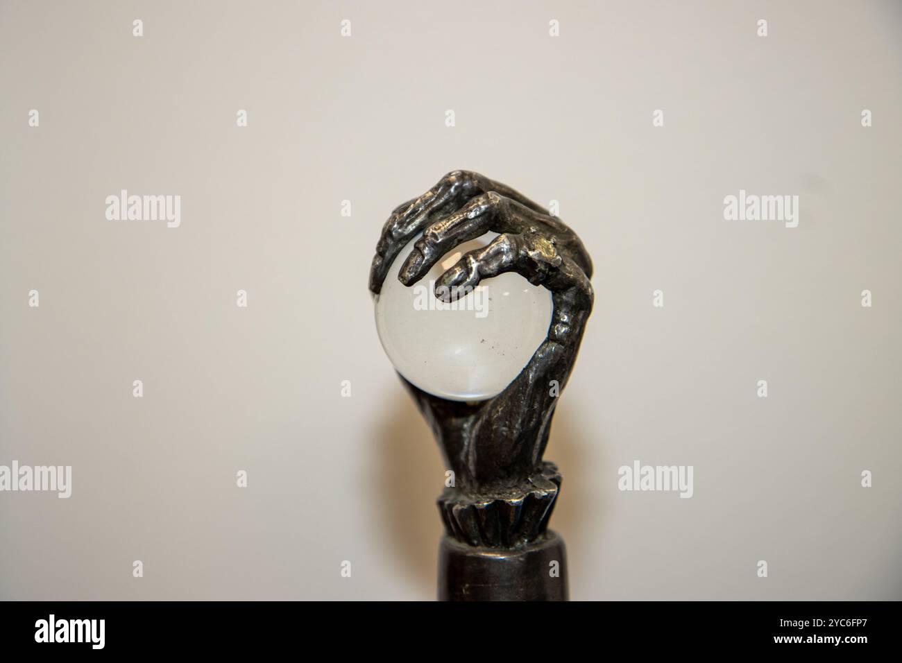 The top of a halloween cane showing a skeleton holding a crystal ball ...