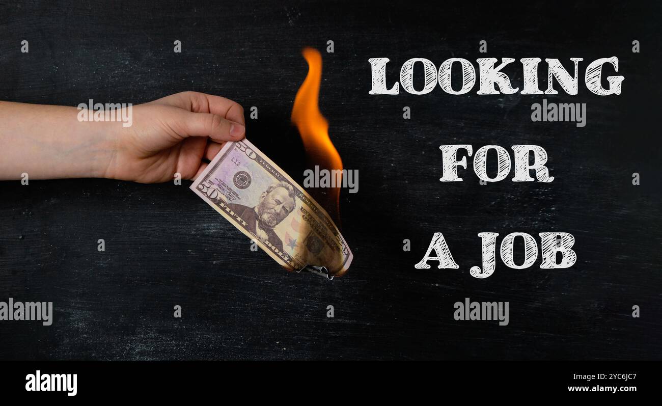 Hand holding burning dollar bill with looking for a job text Stock ...